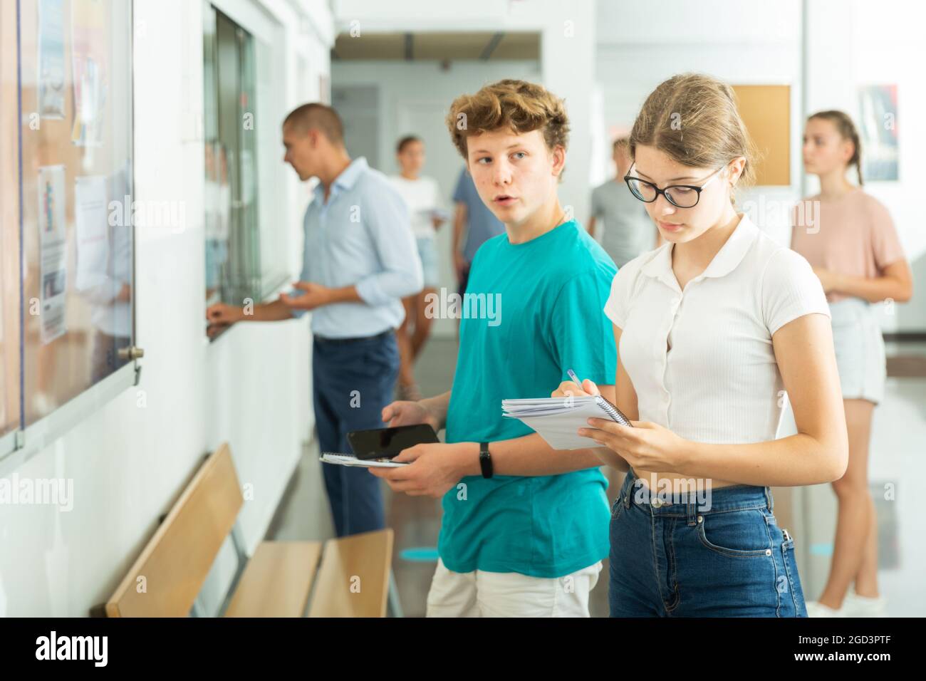 Students record and photograph class schedules in college lobby Stock ...