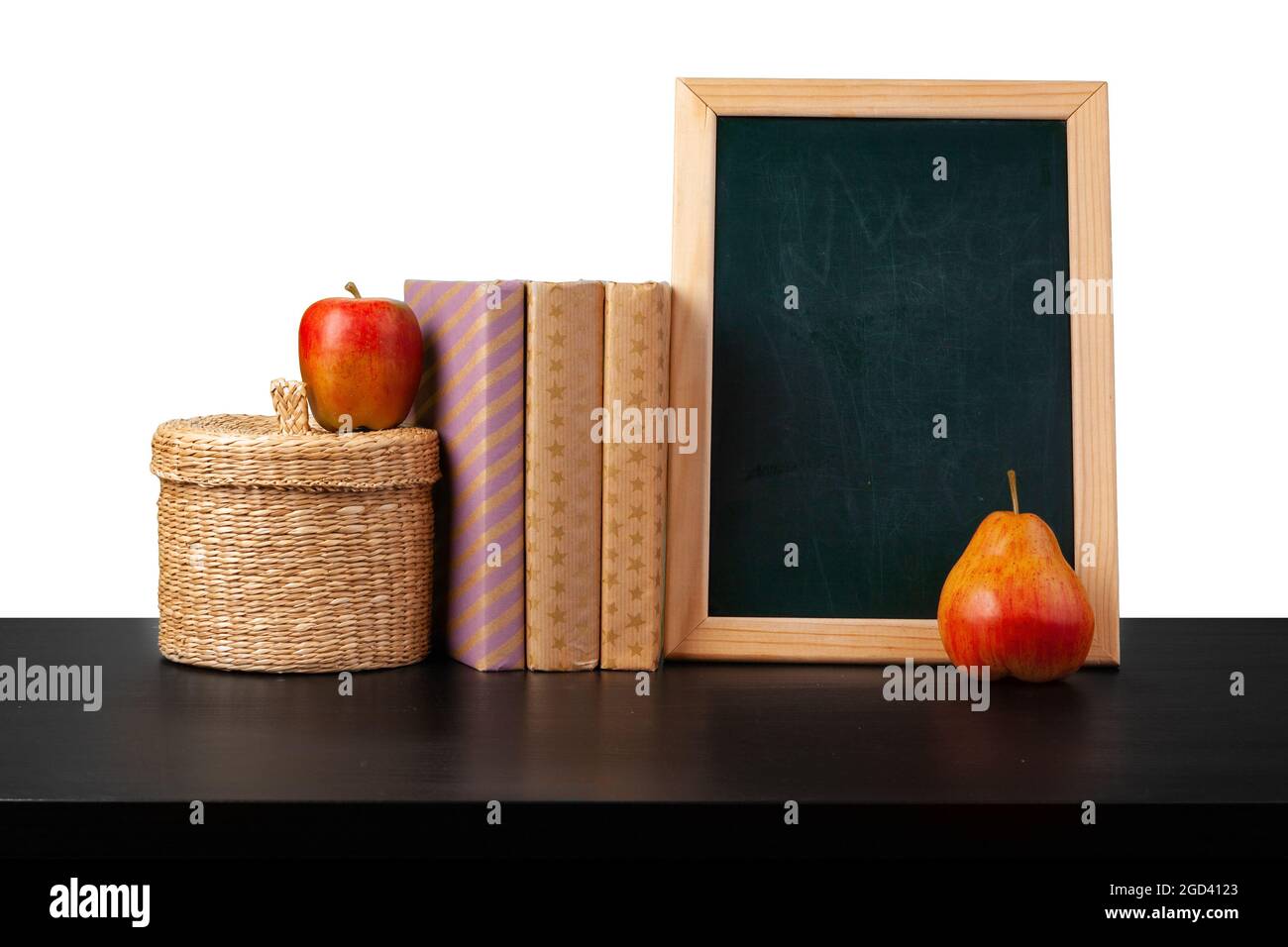Stack of books and apple on tabletop against white background Stock ...