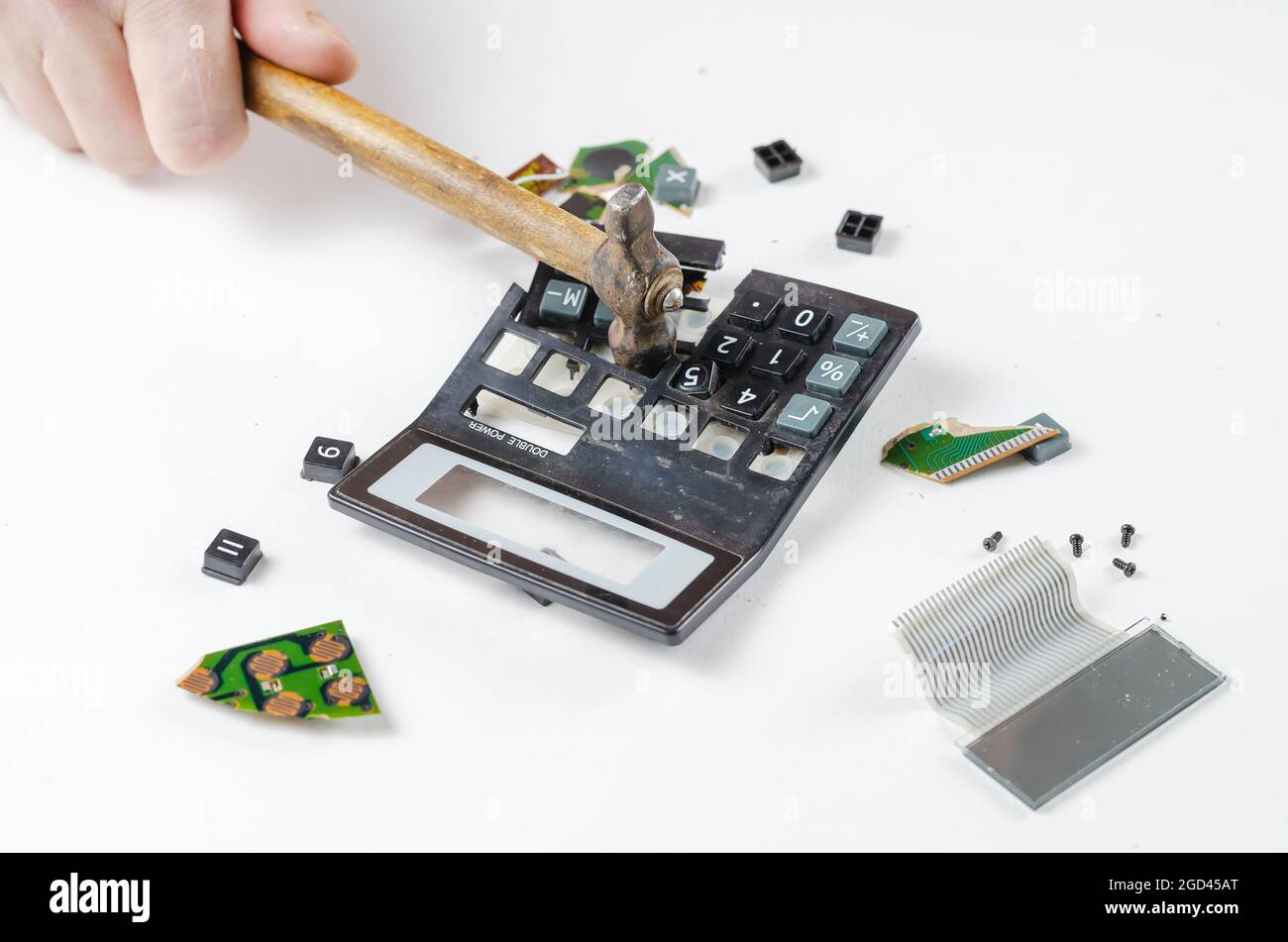 Nervous, irritated man smashes calculator with hammer. His hand hits ...