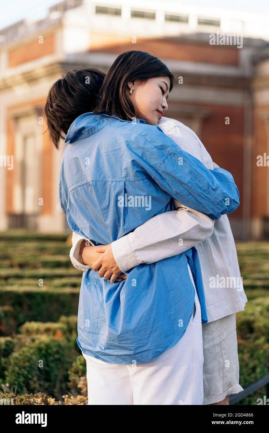 Cool and young asian hugging each other and enjoying a day in the city ...