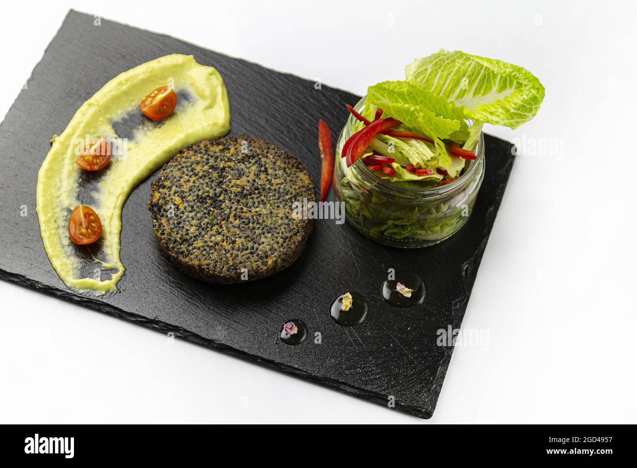 Black quinoa cutlet with salad and hummus on white background Stock ...