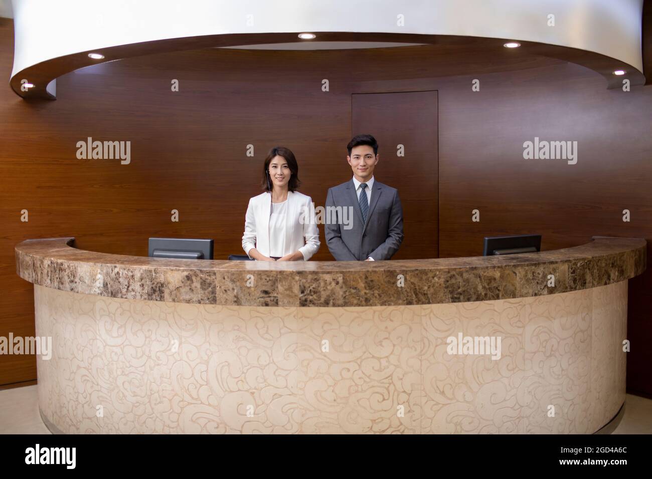 Hotel receptionists at front desk Stock Photo - Alamy