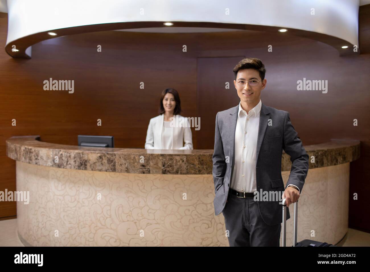 Confident businessman leaving hotel Stock Photo - Alamy