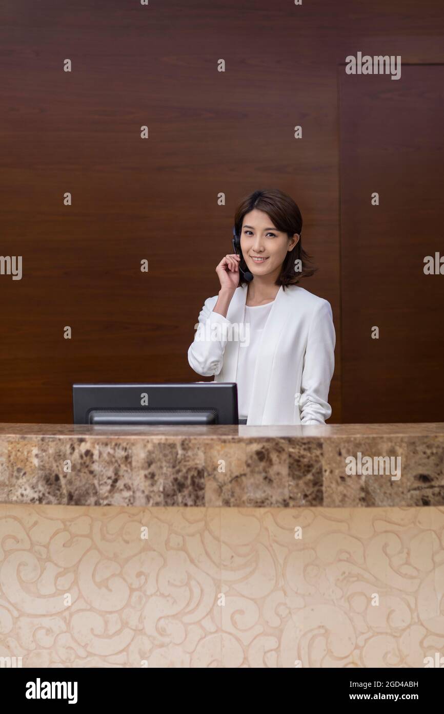 Chinese woman hotel receptionist hi-res stock photography and images ...