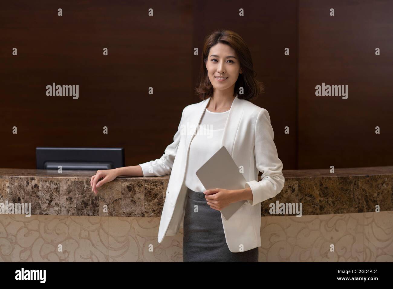 Hotel manager in hotel lobby Stock Photo - Alamy