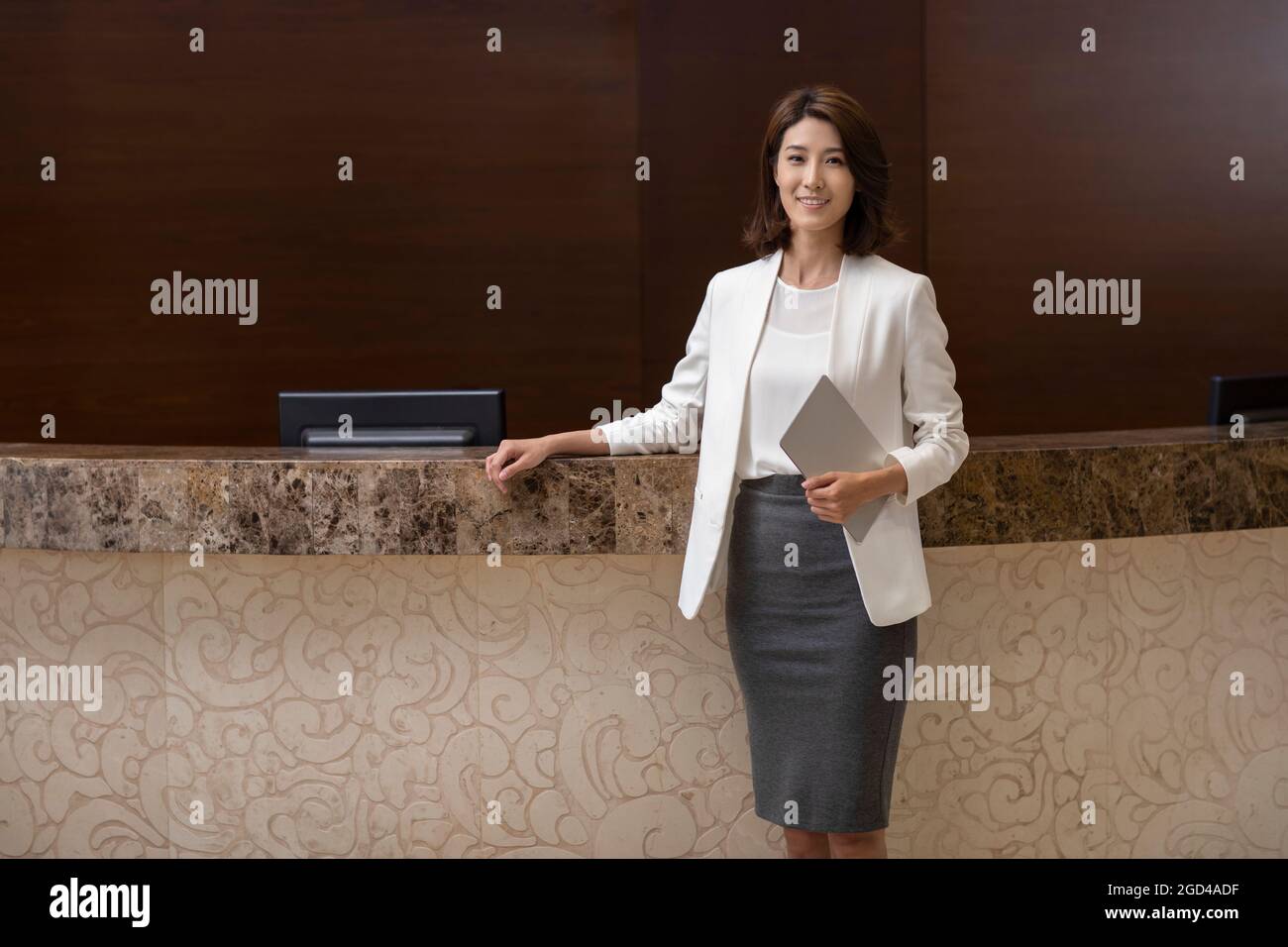 Hotel manager in hotel lobby Stock Photo - Alamy