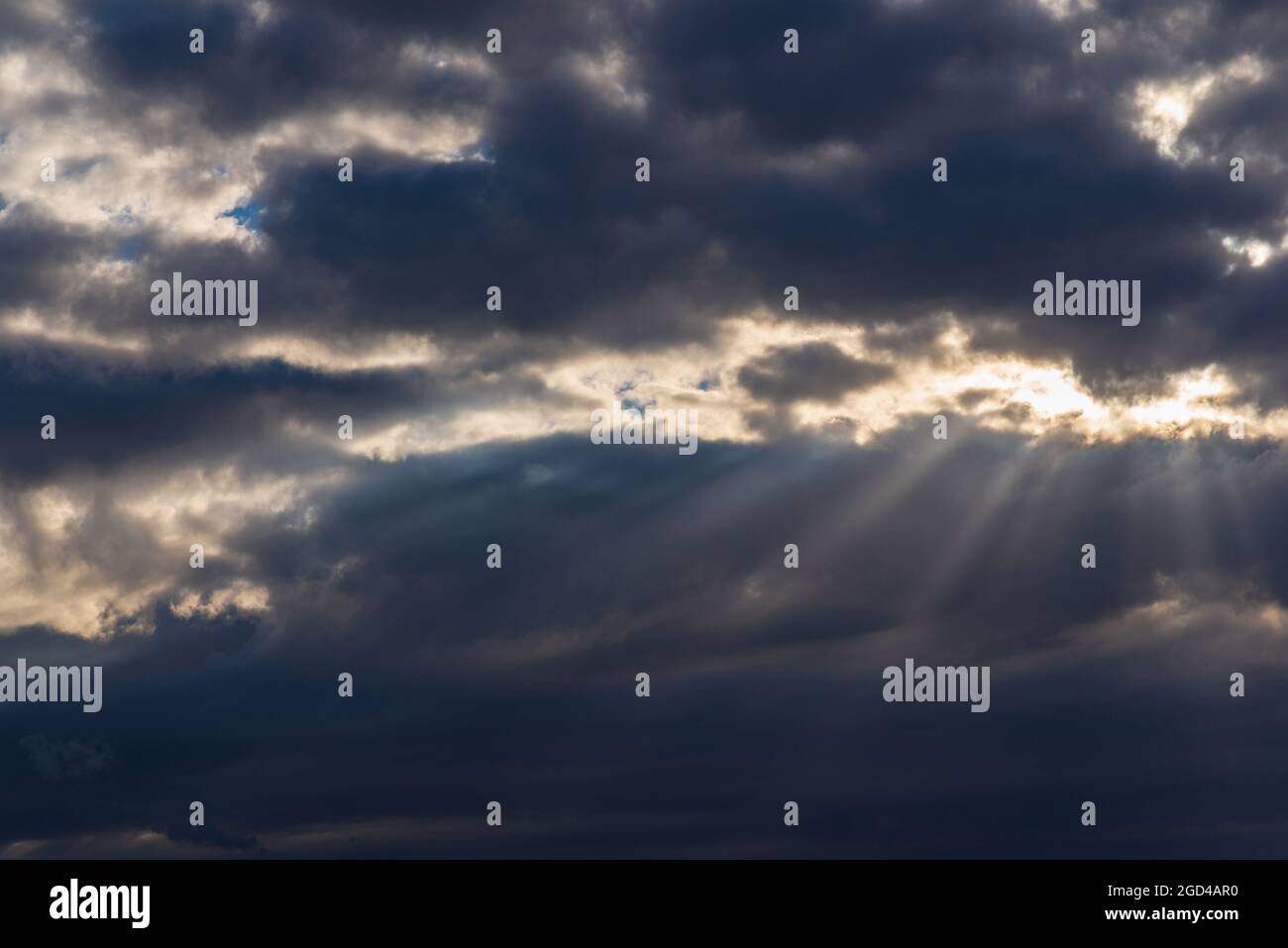 Rays of light shining throug dark clouds.Beautiful dramatic sky with ...