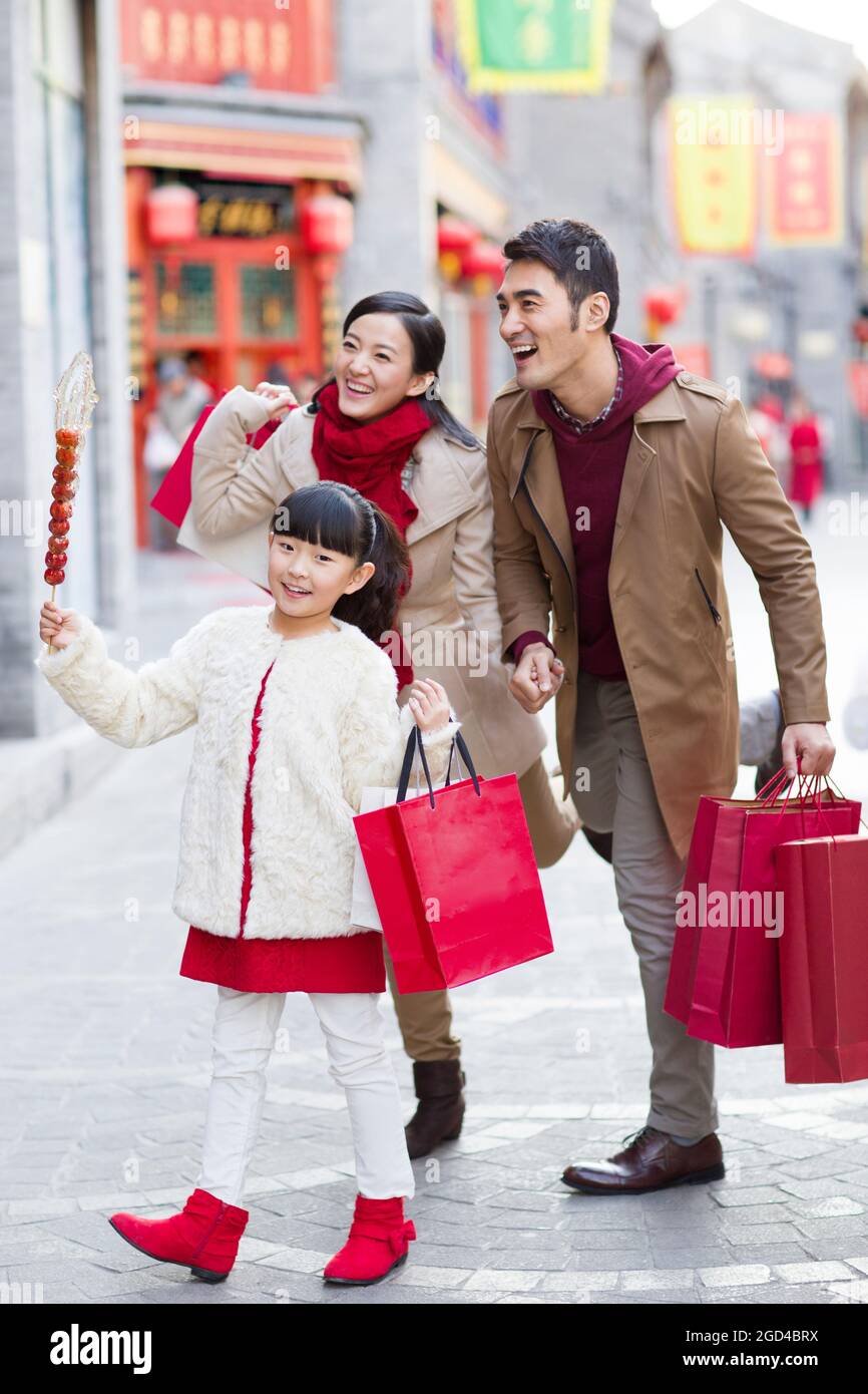 Happy family shopping for Chinese New Year Stock Photo - Alamy