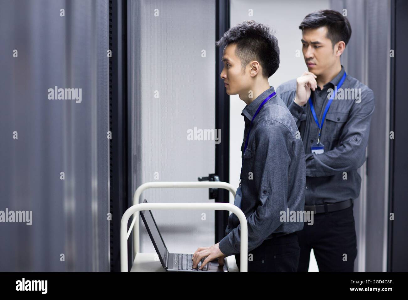 Technicians doing maintenance in computer room Stock Photo - Alamy