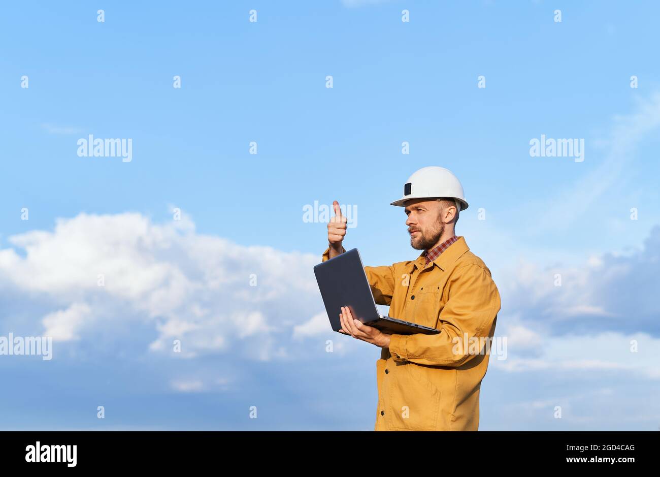 Making thumbs up gesture. Bearded cute caucasian chief engineer ...