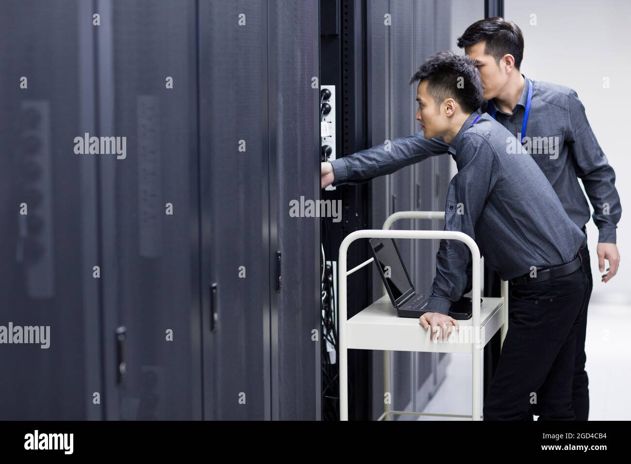 Technicians doing maintenance in computer room Stock Photo - Alamy