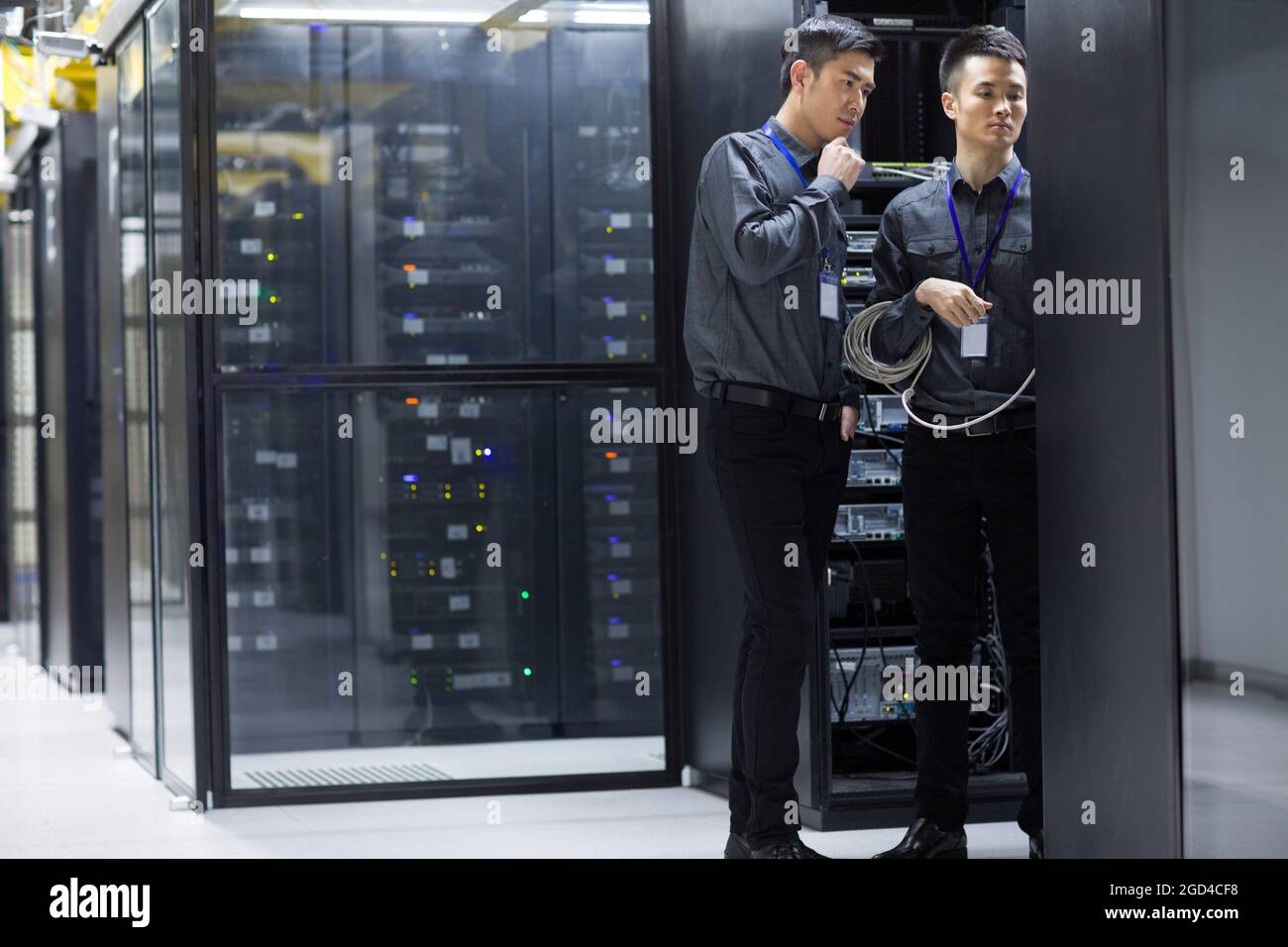 Technicians doing maintenance in computer room Stock Photo - Alamy