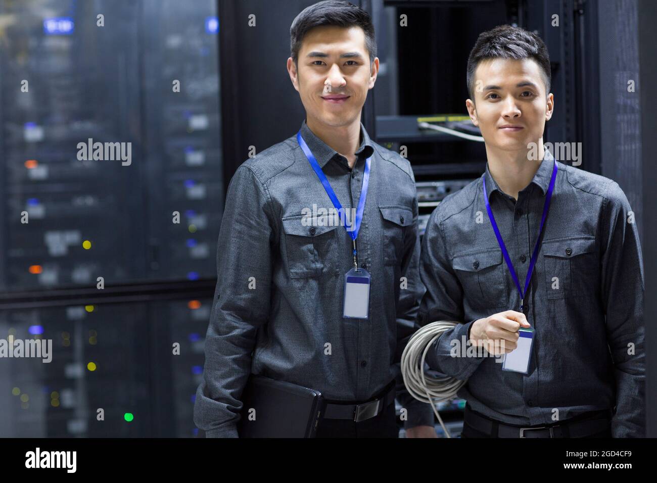 Technicians doing maintenance in computer room Stock Photo - Alamy