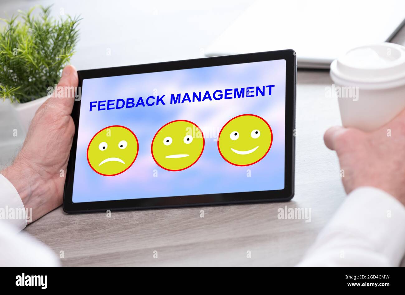 Tablet screen displaying a feedback management concept Stock Photo - Alamy