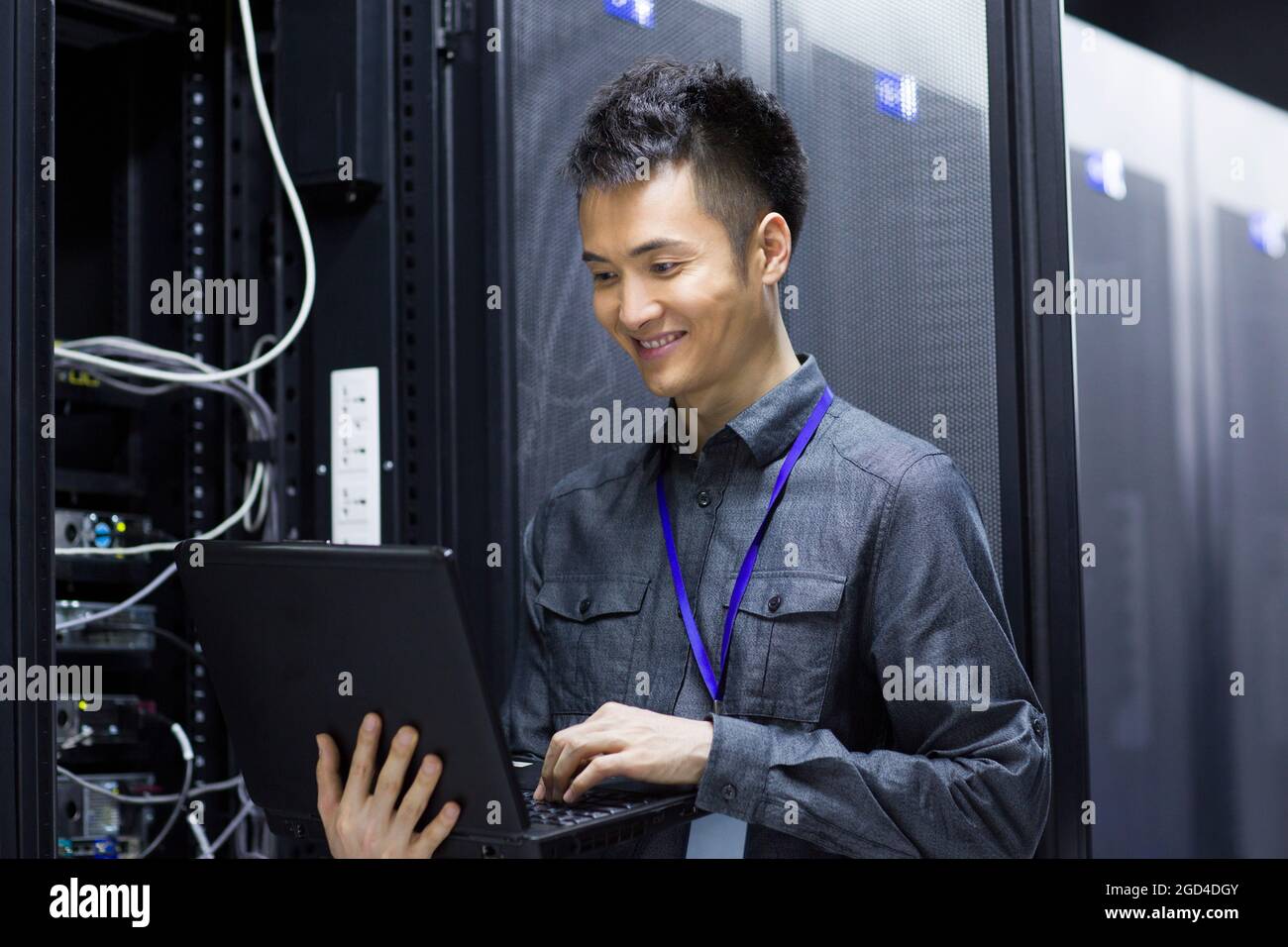 Technician doing maintenance in computer room Stock Photo - Alamy
