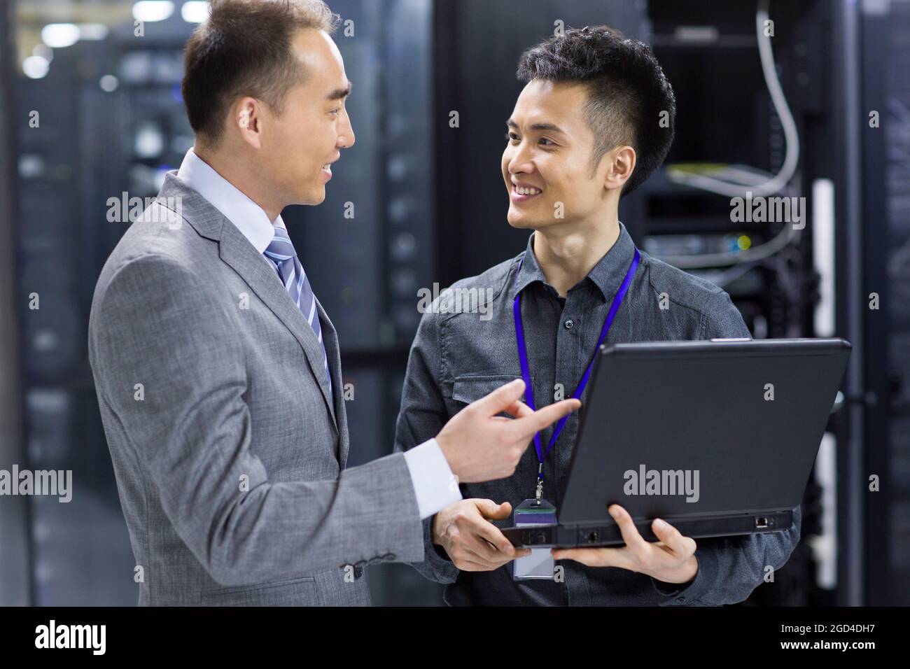 Businessmen talking in computer room Stock Photo - Alamy