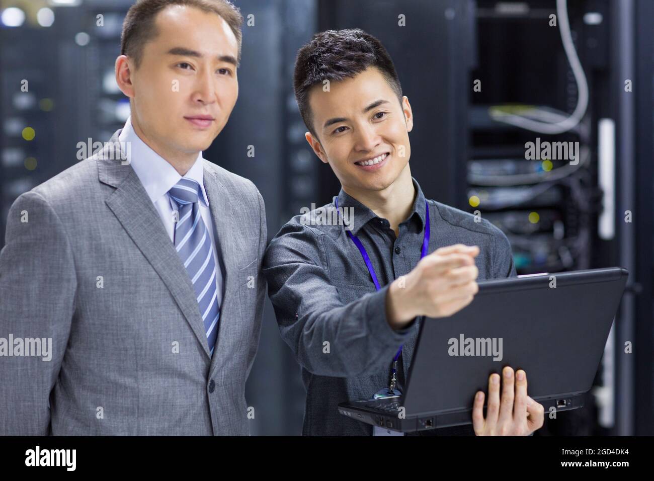 Businessmen talking in computer room Stock Photo - Alamy