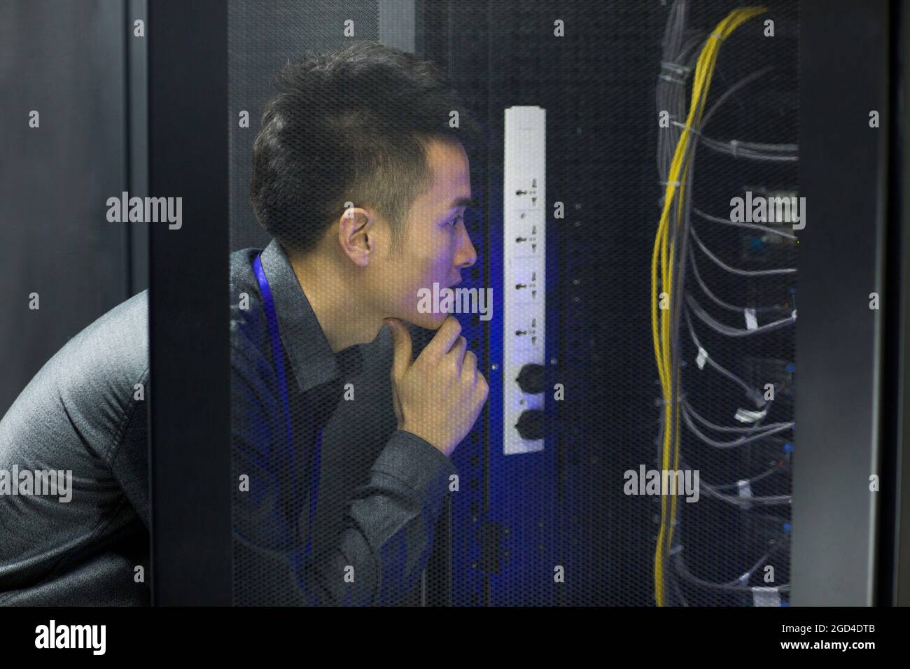 Technician doing maintenance in computer room Stock Photo - Alamy