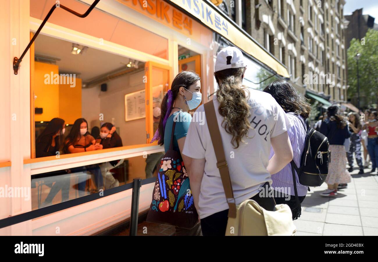 London, England, UK. Young people inside and outside Bunsik Korean ...