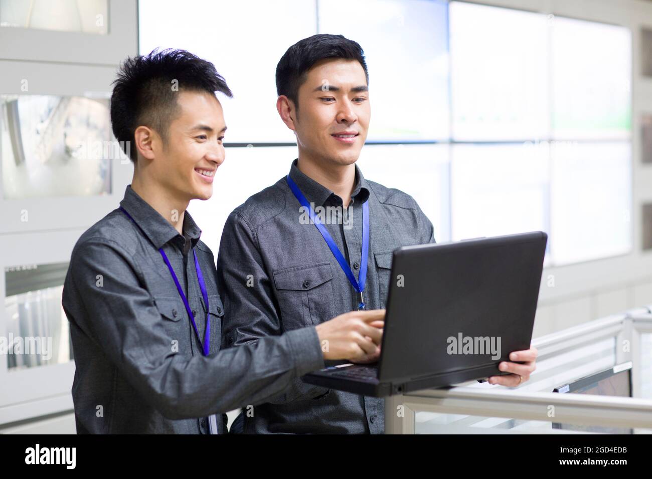 Two young smiling programmers hi-res stock photography and images - Alamy