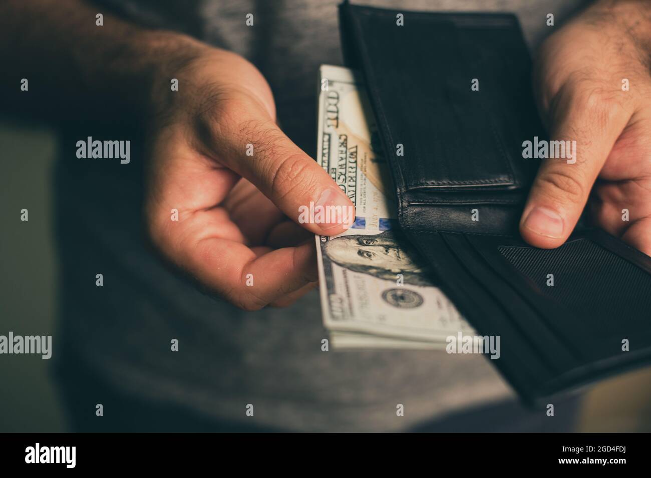 Counting money in black leather hi-res stock photography and images - Alamy
