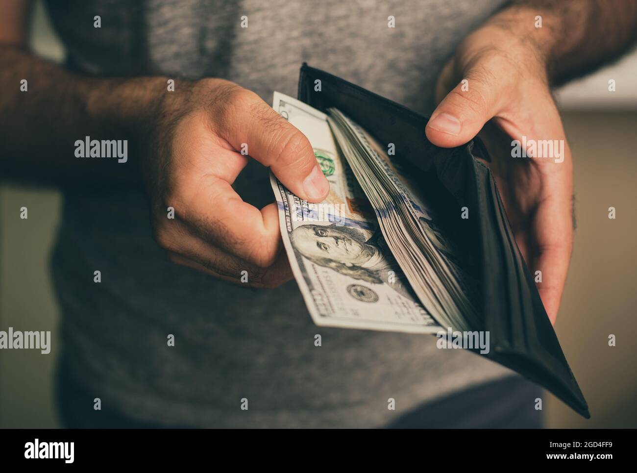 Counting money in black leather hi-res stock photography and images - Alamy