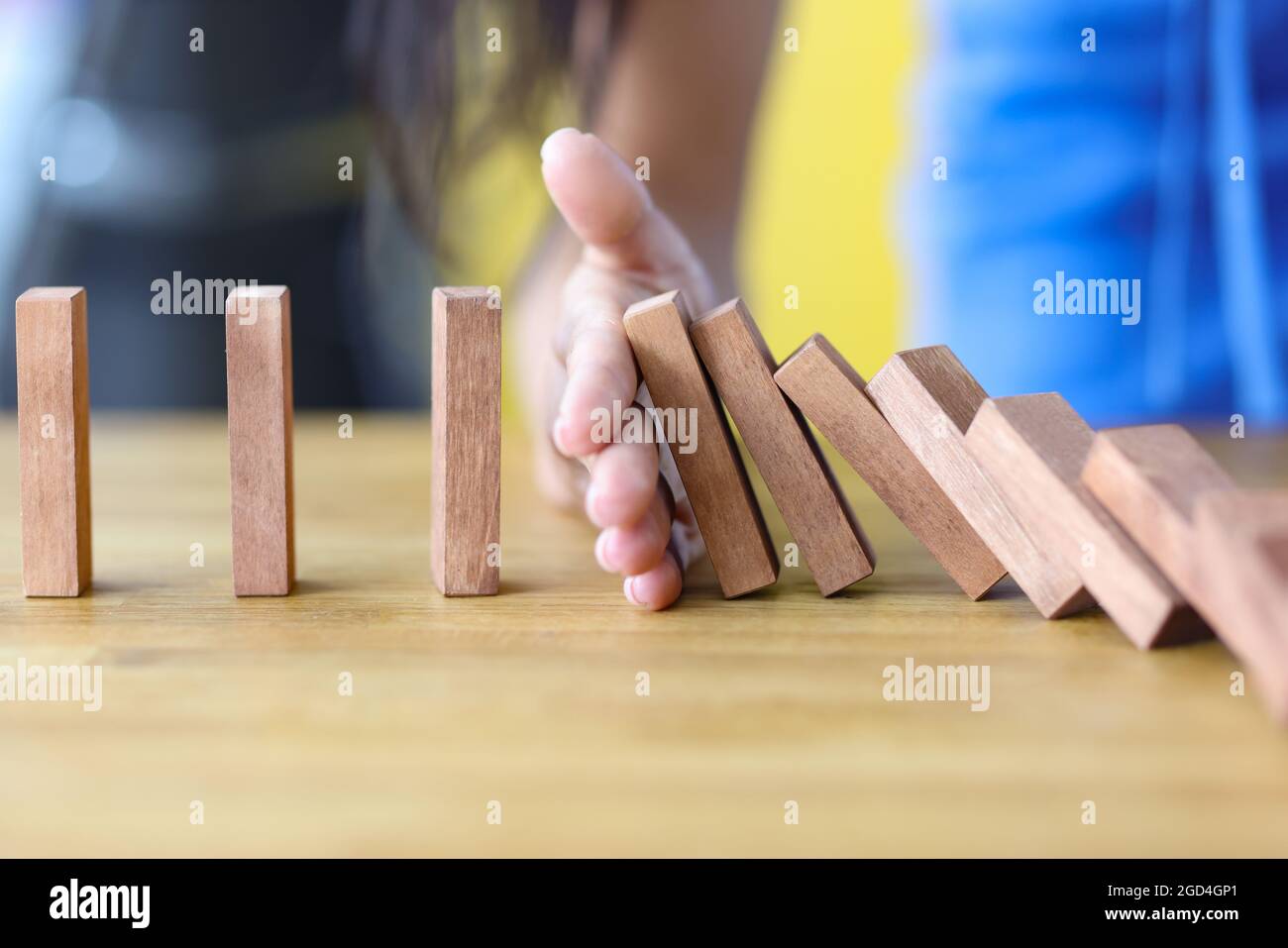 Business woman protects wooden block from falling planning and strategy ...