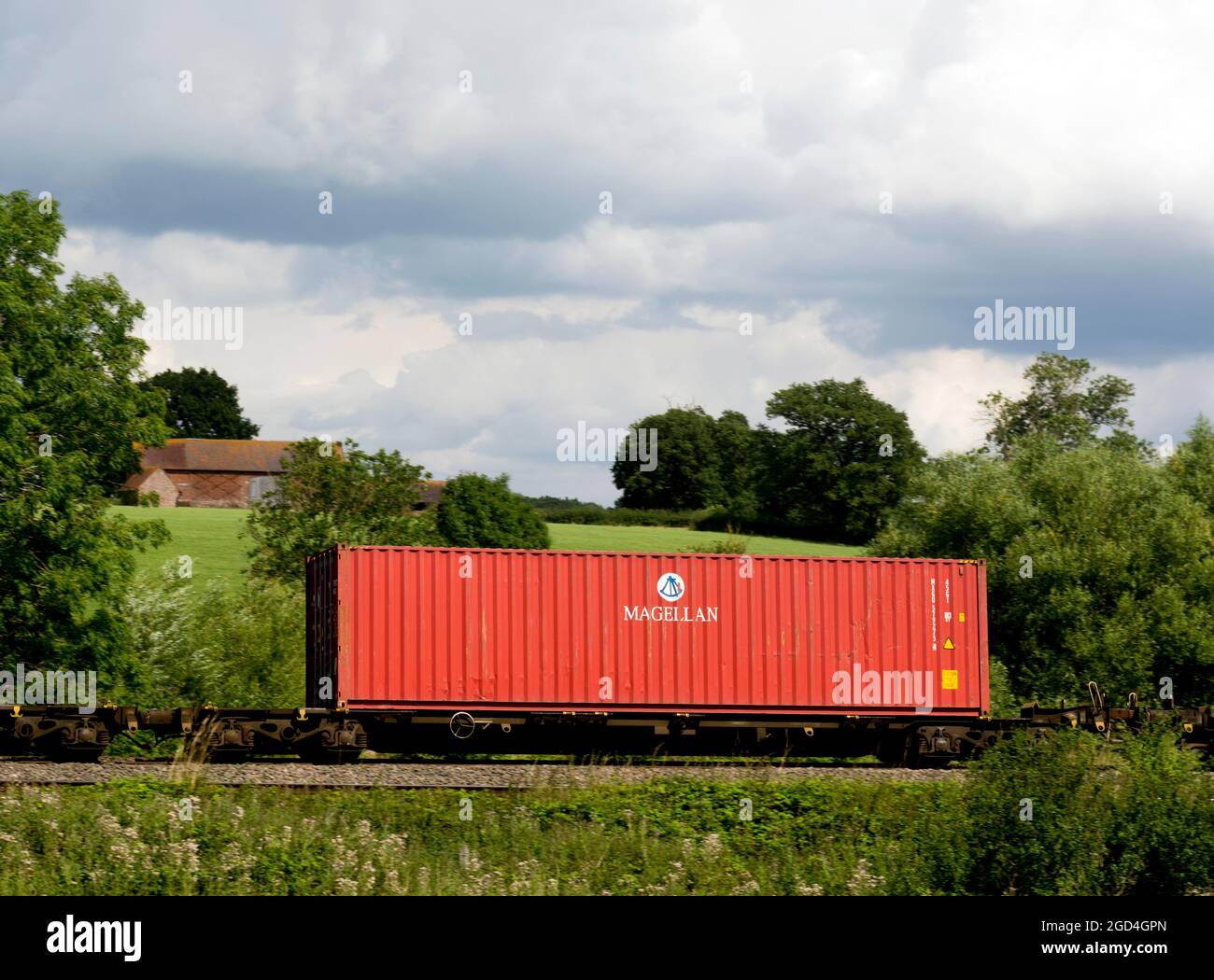 A Magellan shipping container on a freightliner train, Warwickshire, UK ...