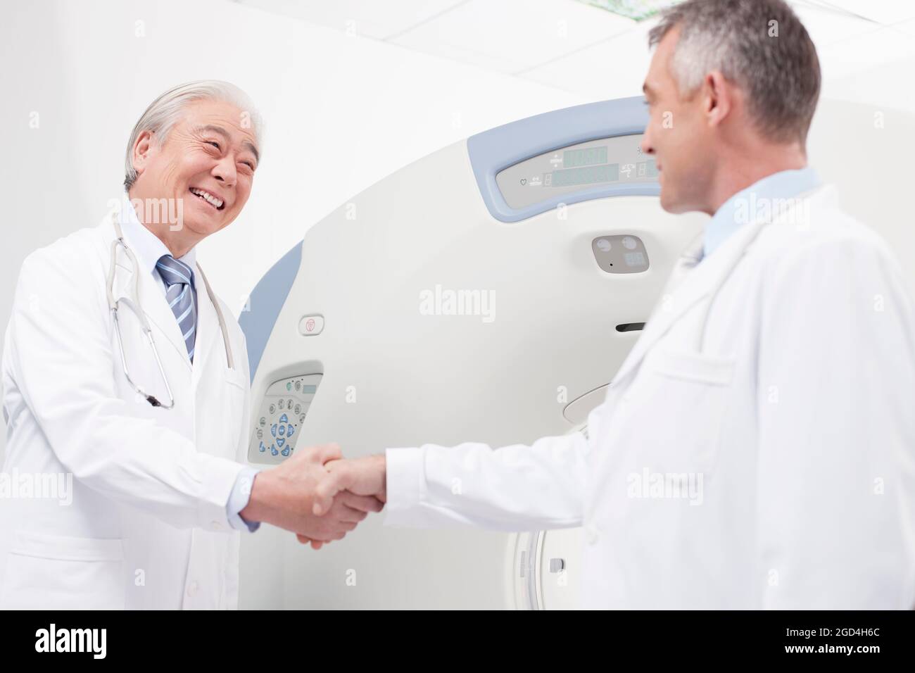 Doctors dong handshake in CT room Stock Photo - Alamy