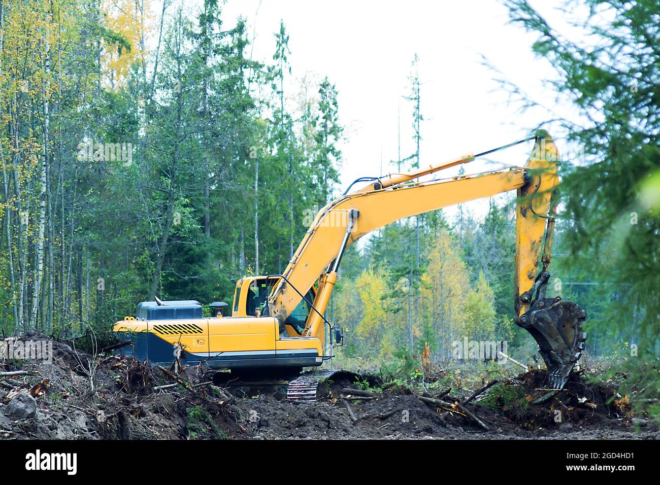 The excavator performs the work of a bulldozer with a shovel-uprooting ...
