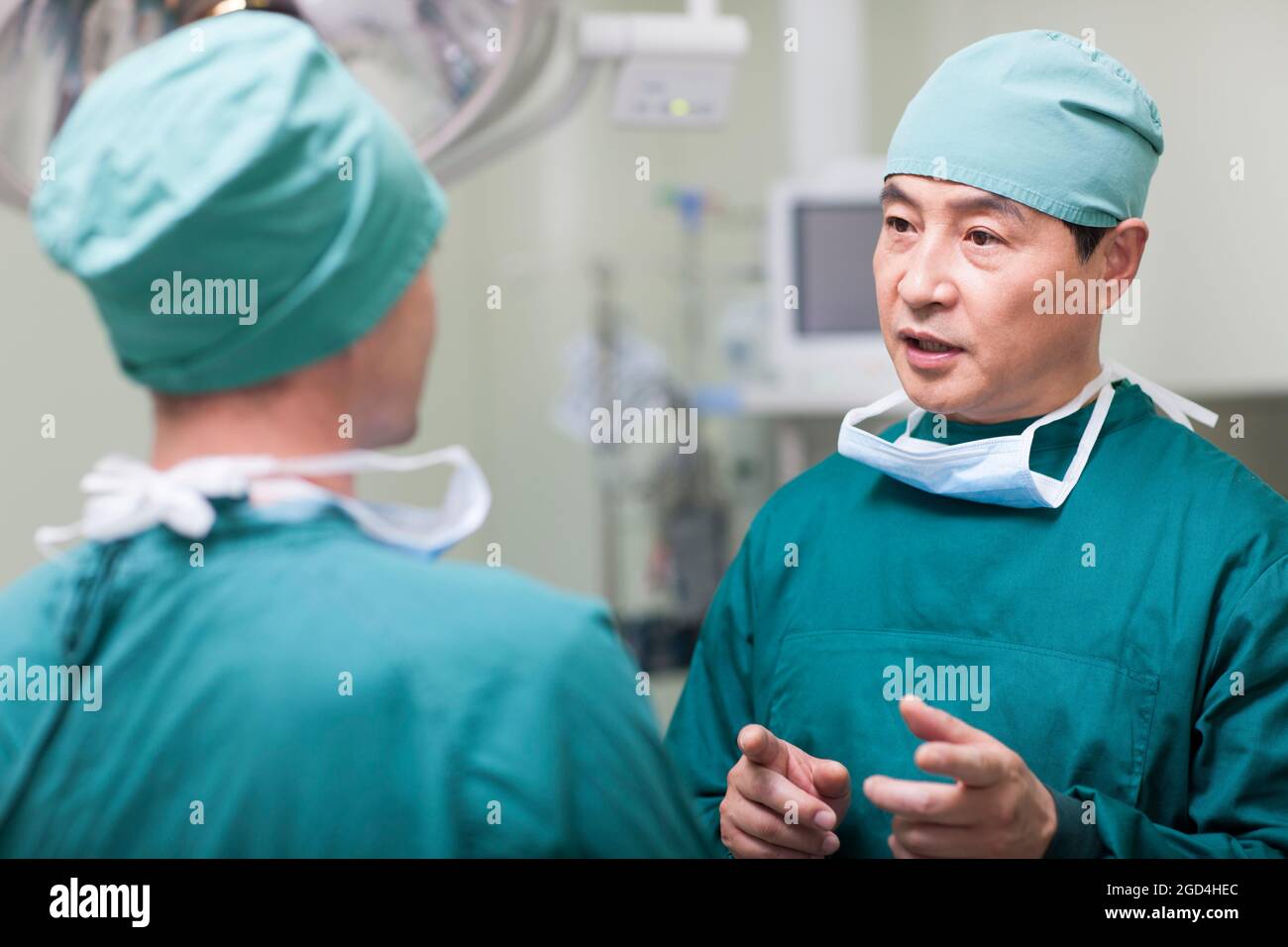 Surgeons talking in operating room Stock Photo - Alamy