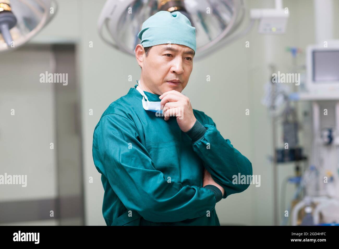 Portrait of surgeon hand on chin Stock Photo - Alamy