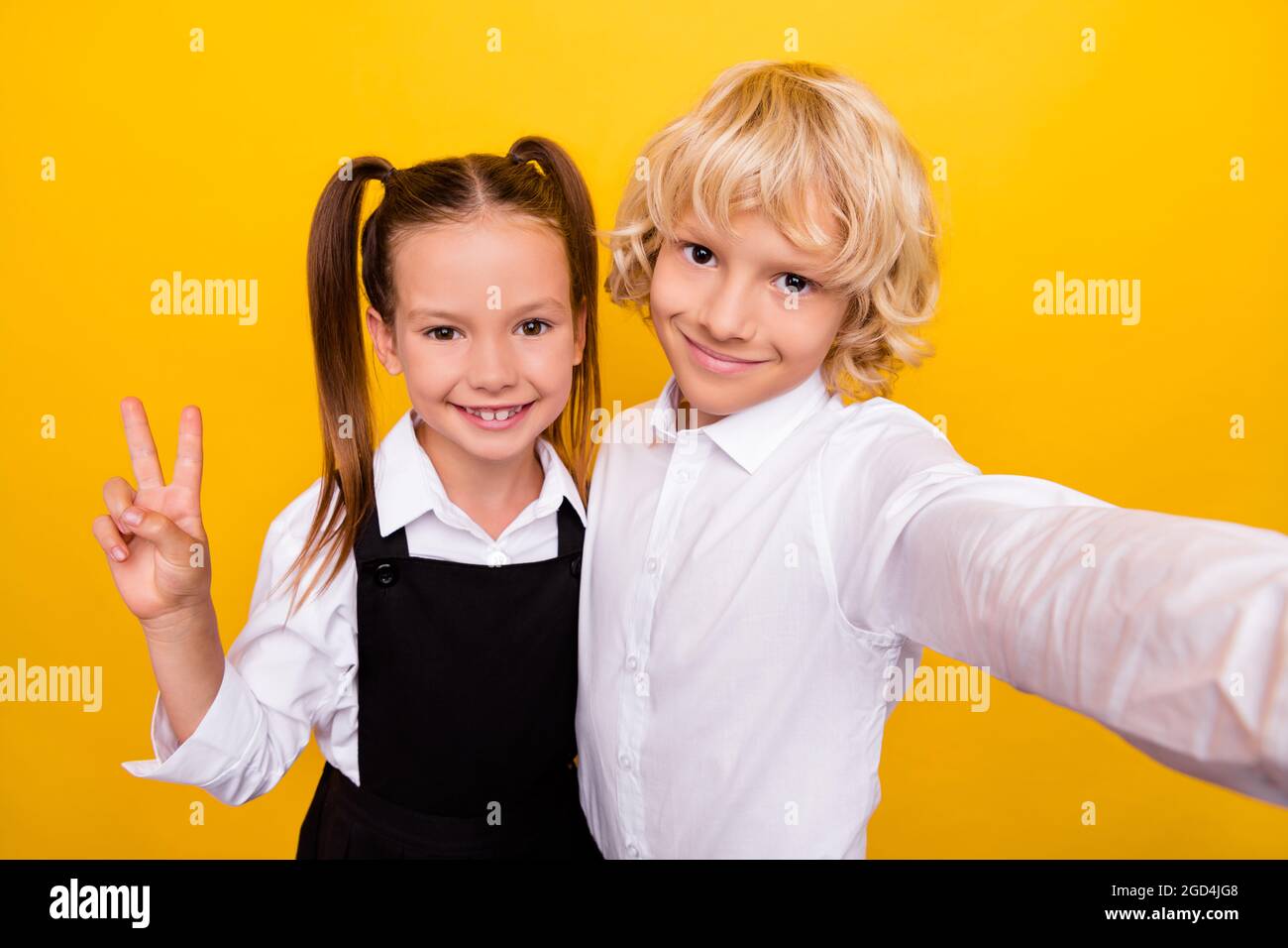 Photo of cheerful friendly classmate kids take selfie show v-sign wear ...