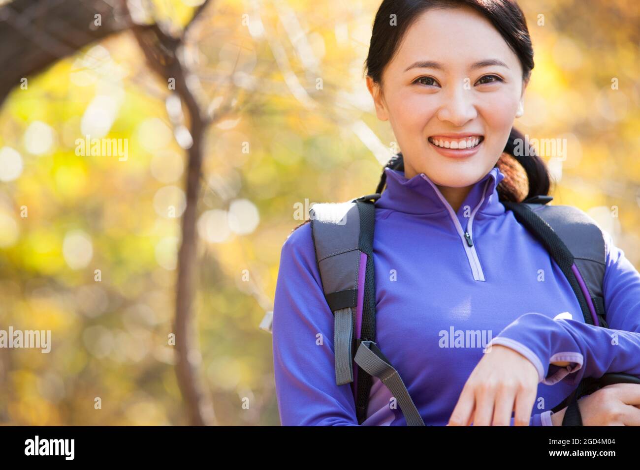 Happy female backpacker on a hike Stock Photo - Alamy