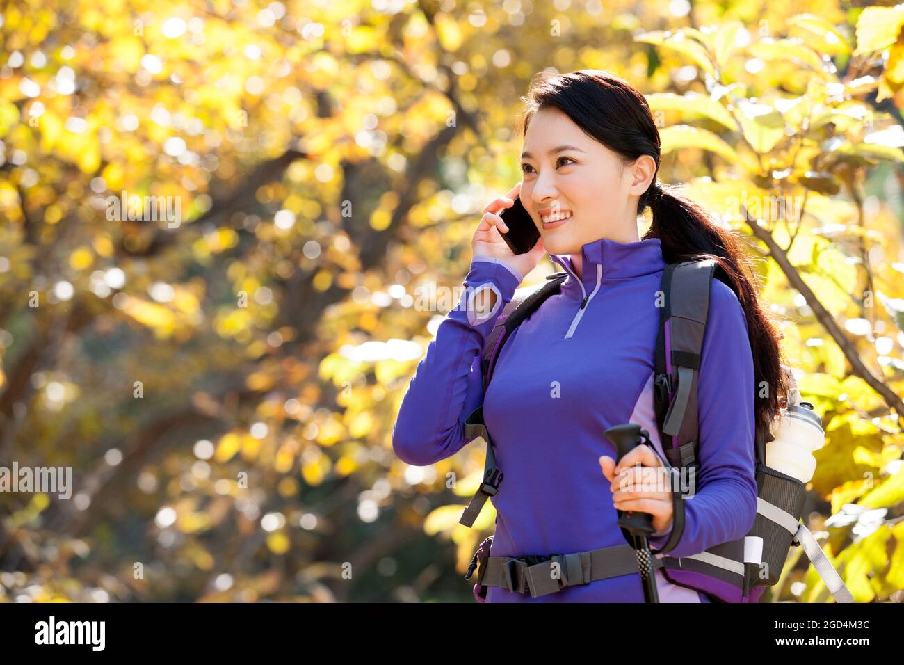 Happy female backpacker on the phone Stock Photo - Alamy