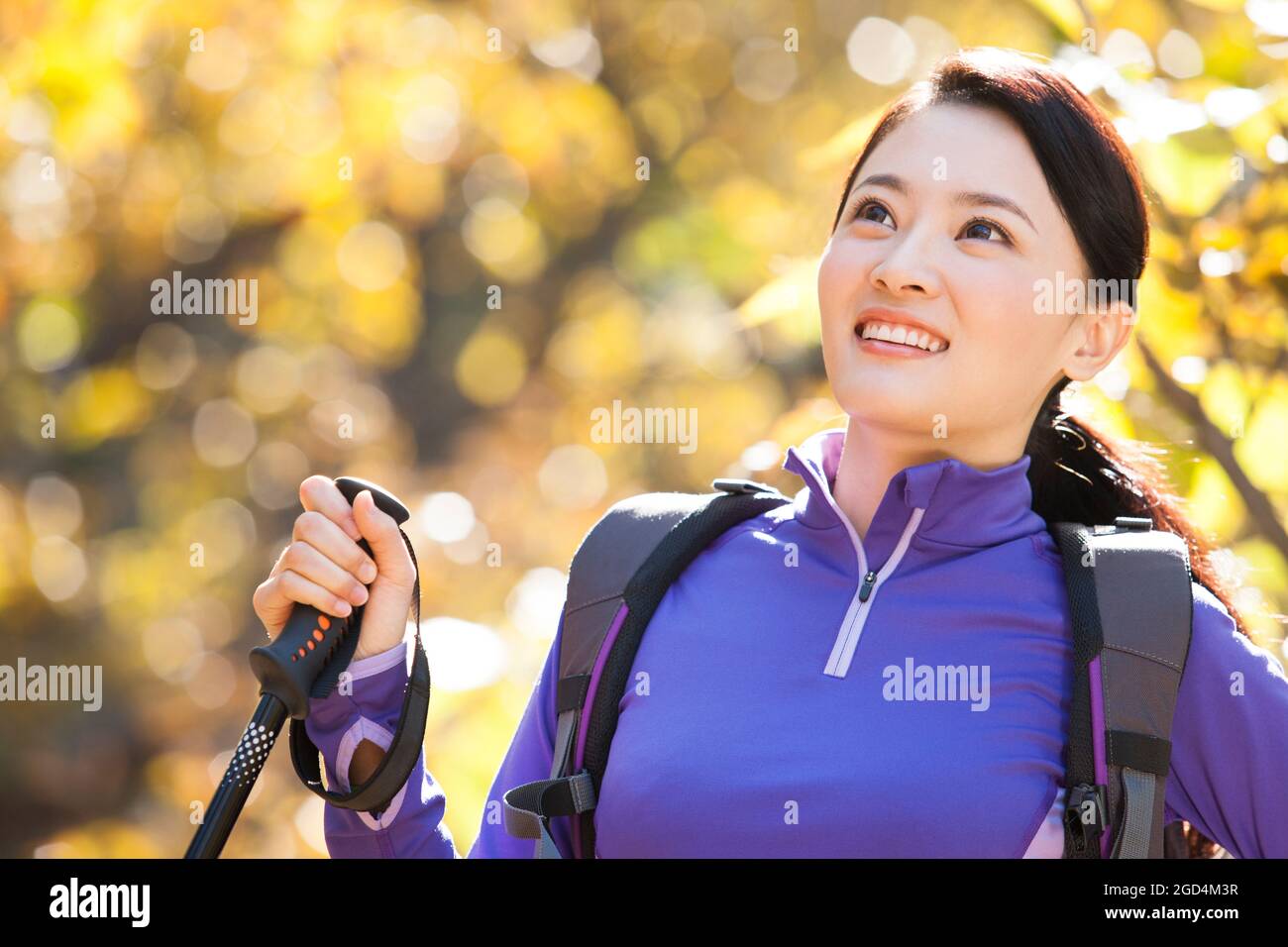 Happy female backpacker on a hike Stock Photo - Alamy