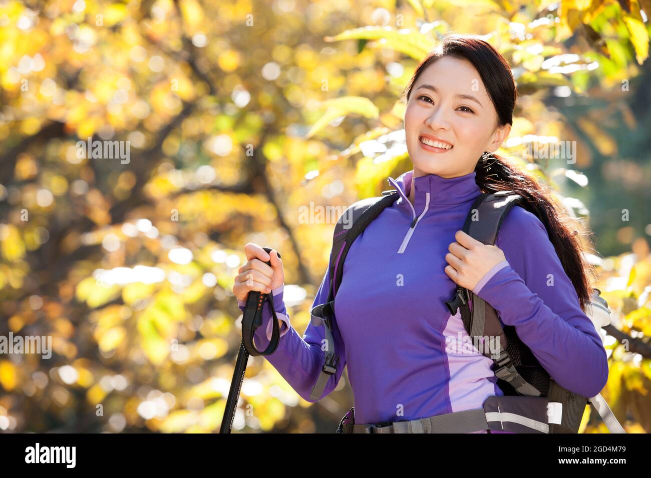 Happy female backpacker on a hike Stock Photo - Alamy