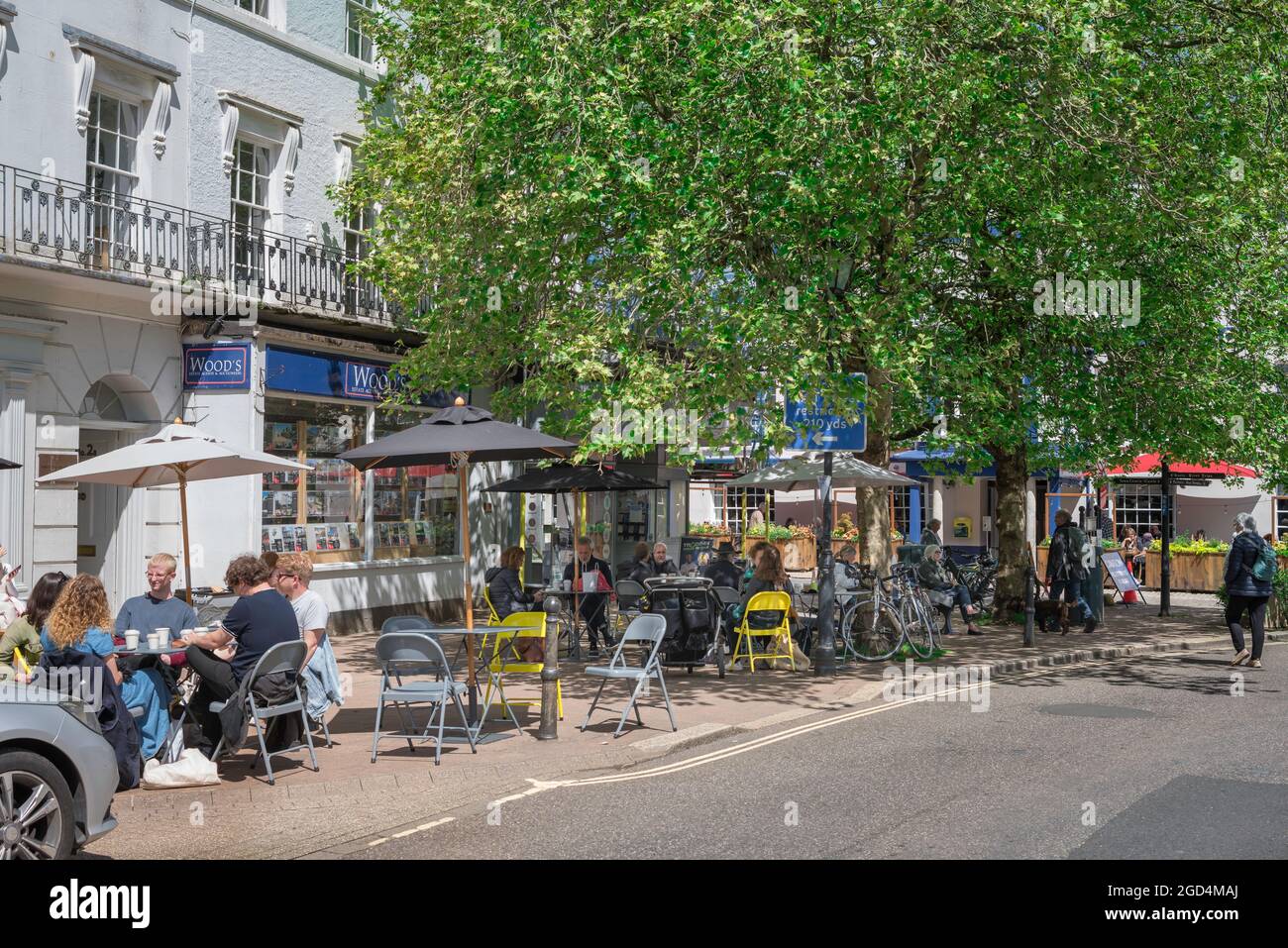 Totnes Devon, view of people in summer relaxing outside cafes and ...