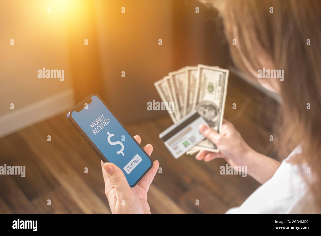Mobile bankning concept, money received screen and credit card in woman ...