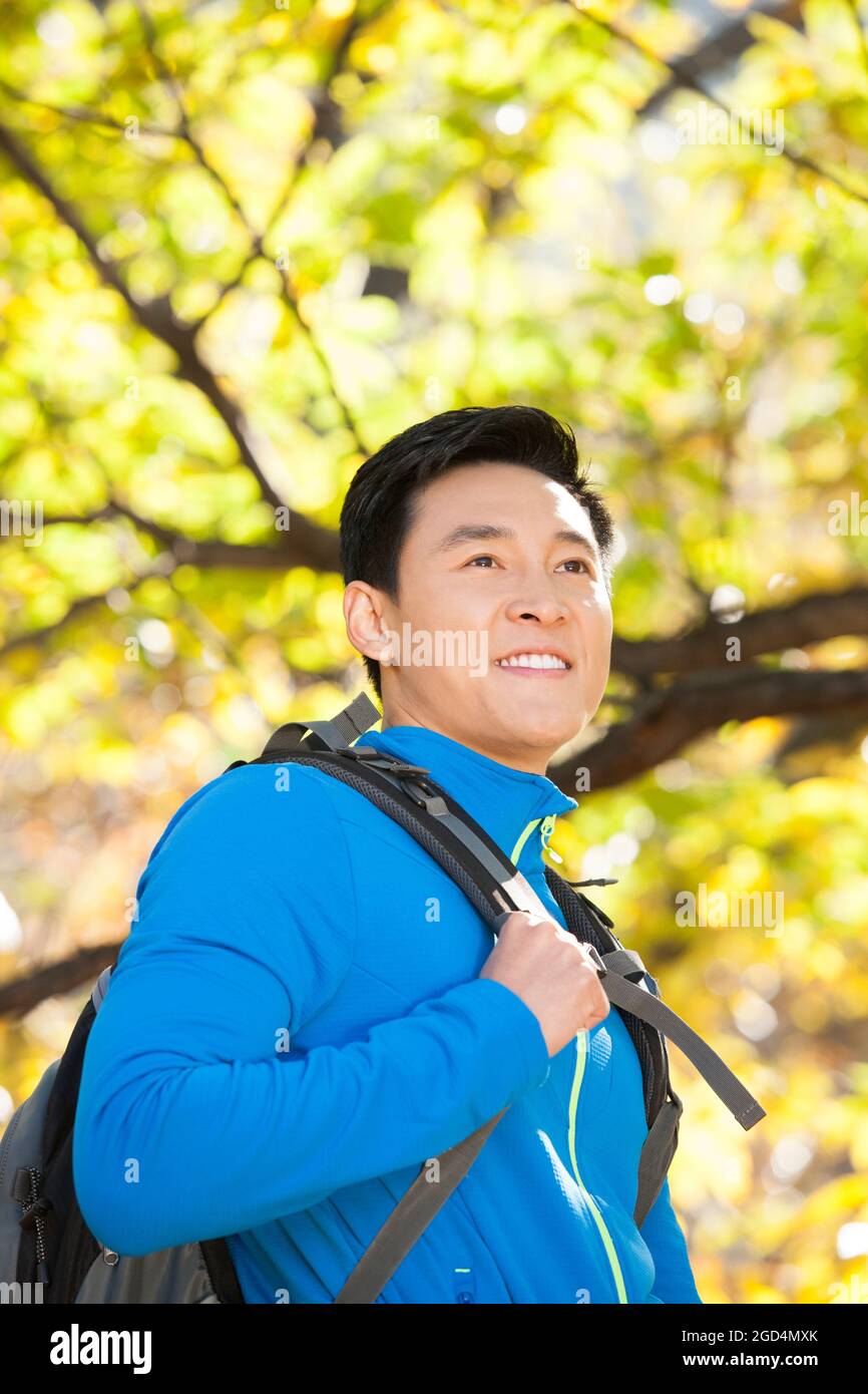 Happy male backpacker on a hike Stock Photo - Alamy