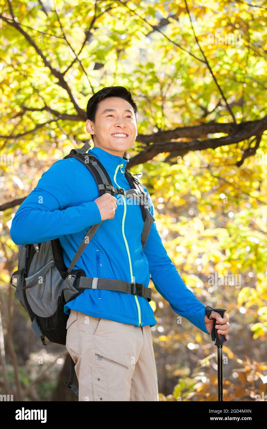 Happy male backpacker on a hike Stock Photo - Alamy