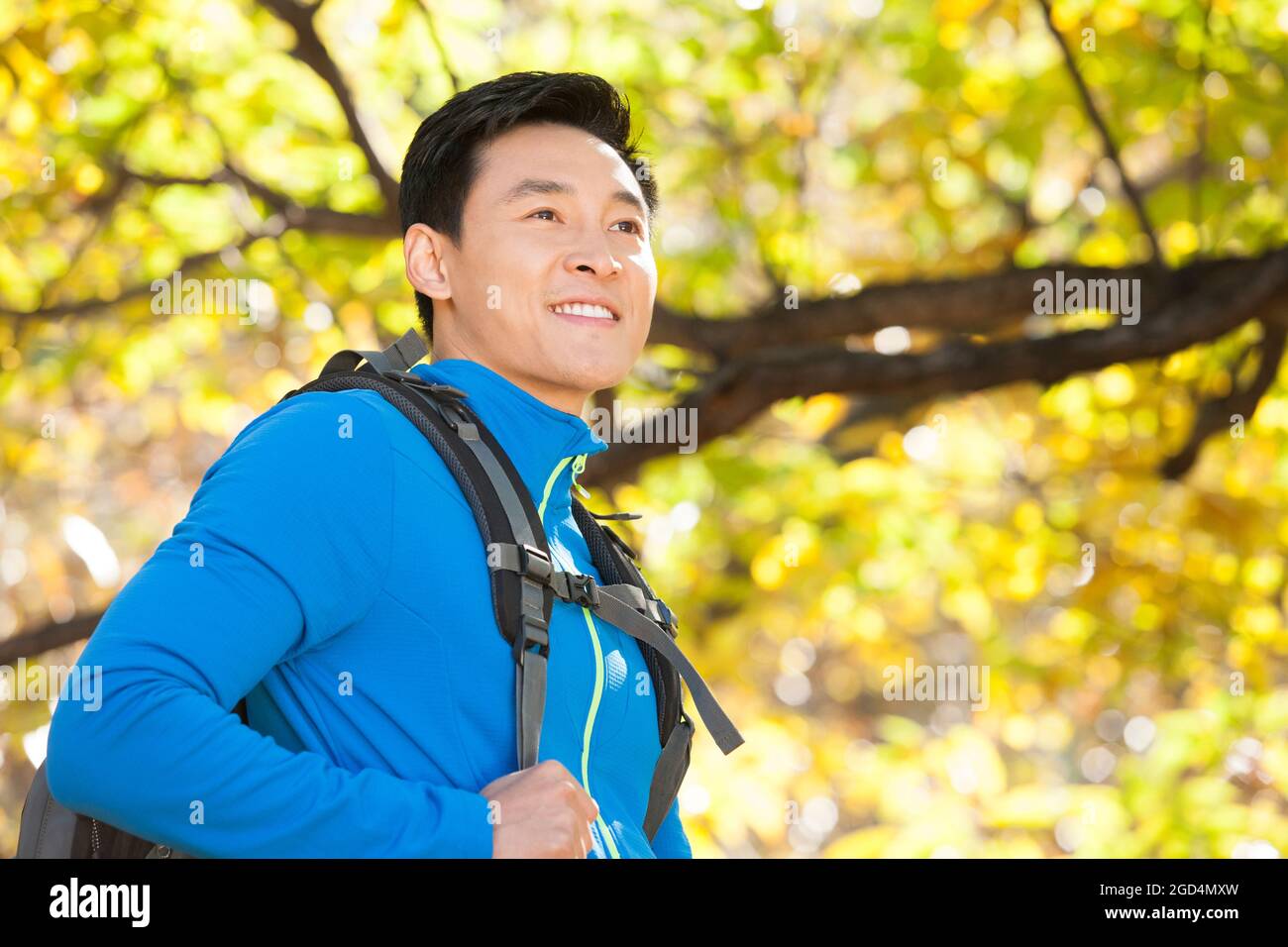 Happy male backpacker on a hike Stock Photo - Alamy