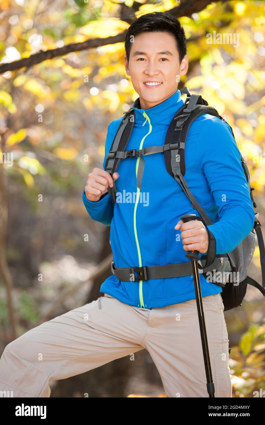 Happy male backpacker on a hike Stock Photo - Alamy