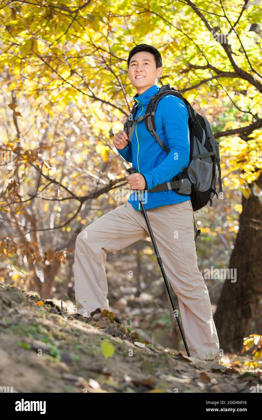 Happy male backpacker on a hike Stock Photo - Alamy