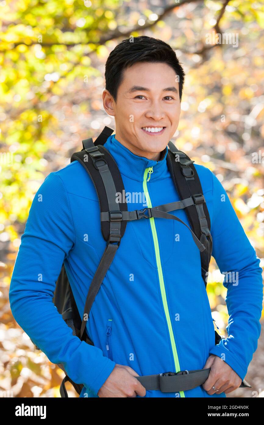 Happy male backpacker on a hike Stock Photo - Alamy