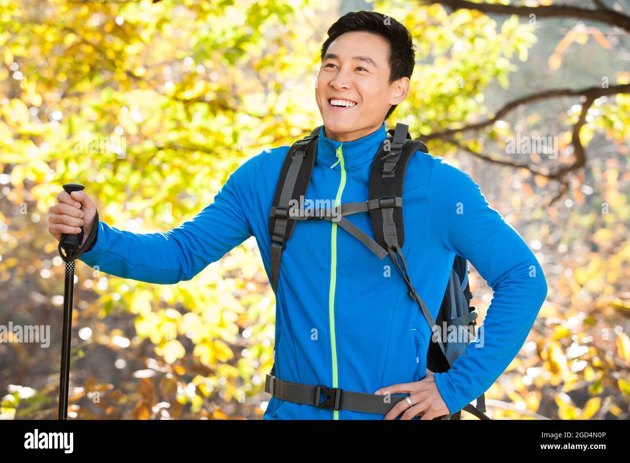 Happy male backpacker on a hike Stock Photo - Alamy
