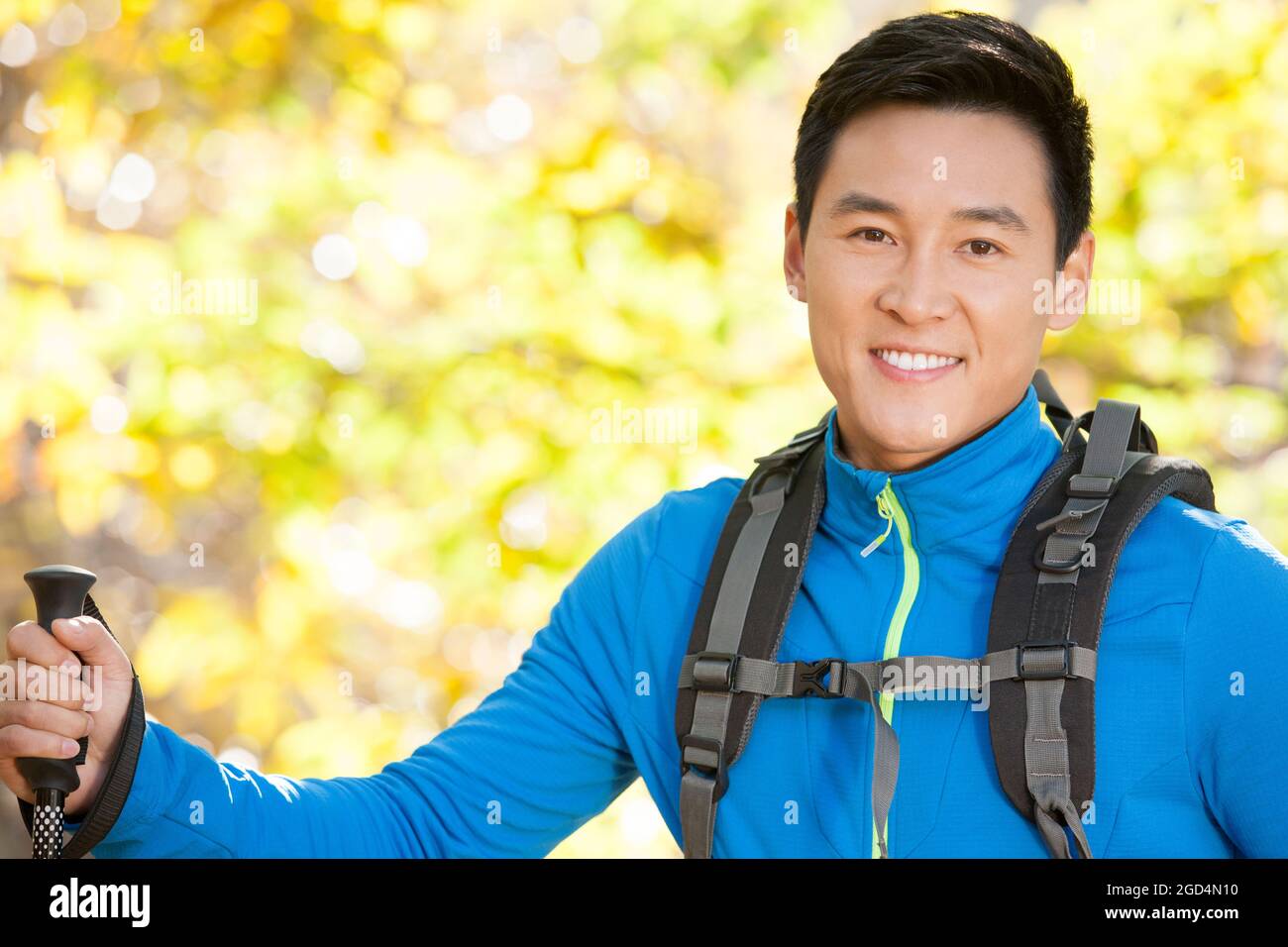 Happy male backpacker on a hike Stock Photo - Alamy