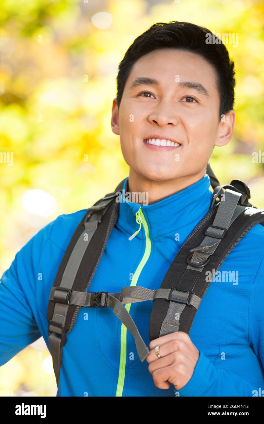 Happy male backpacker on a hike Stock Photo - Alamy