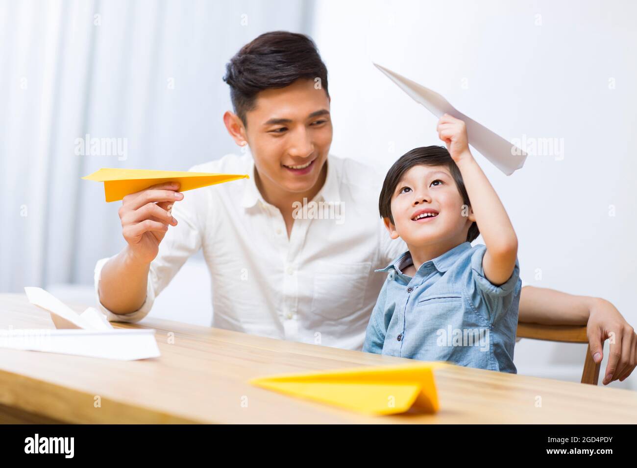 Father an son making paper plane Stock Photo - Alamy