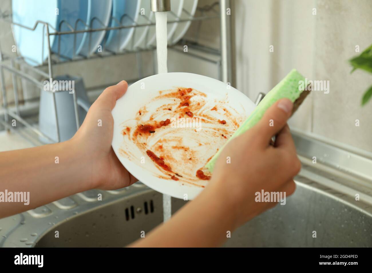 Concept of dishwashing on kitchen basin background Stock Photo - Alamy